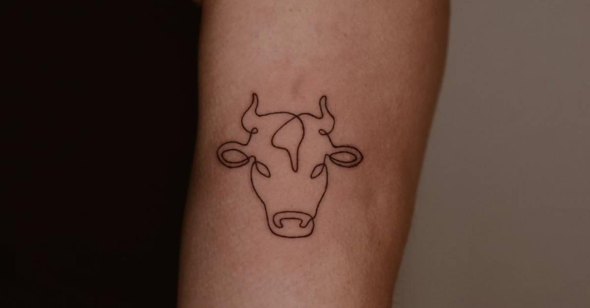One line cow portrai tattoo located on the bicep.
