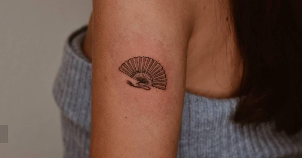 Hand fan tattoo placed on the tricep, illustrative