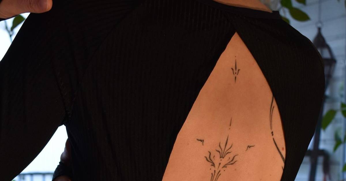 Healed ornamental back composition tattoo.