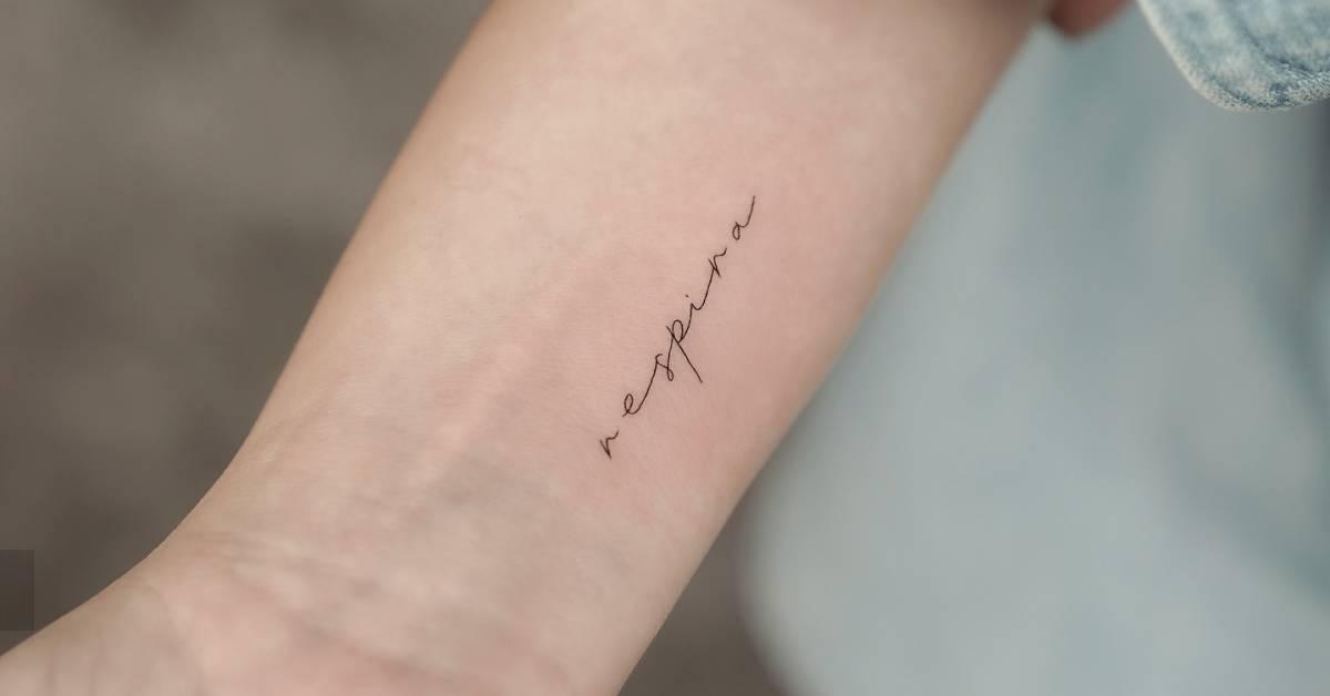 Lettering tattoo of the word "respira" located on the