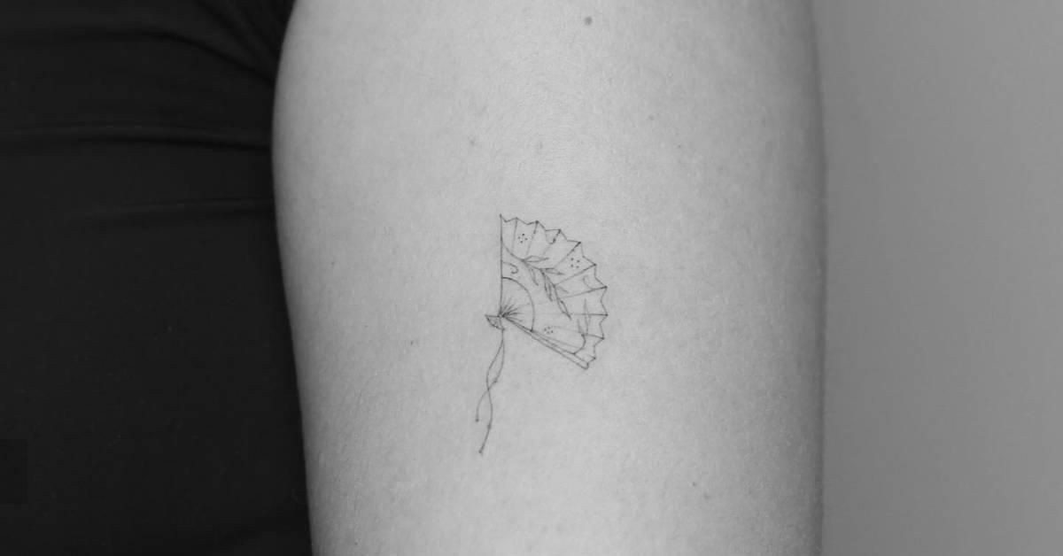 Fine line style hand fan tattoo placed on the upper