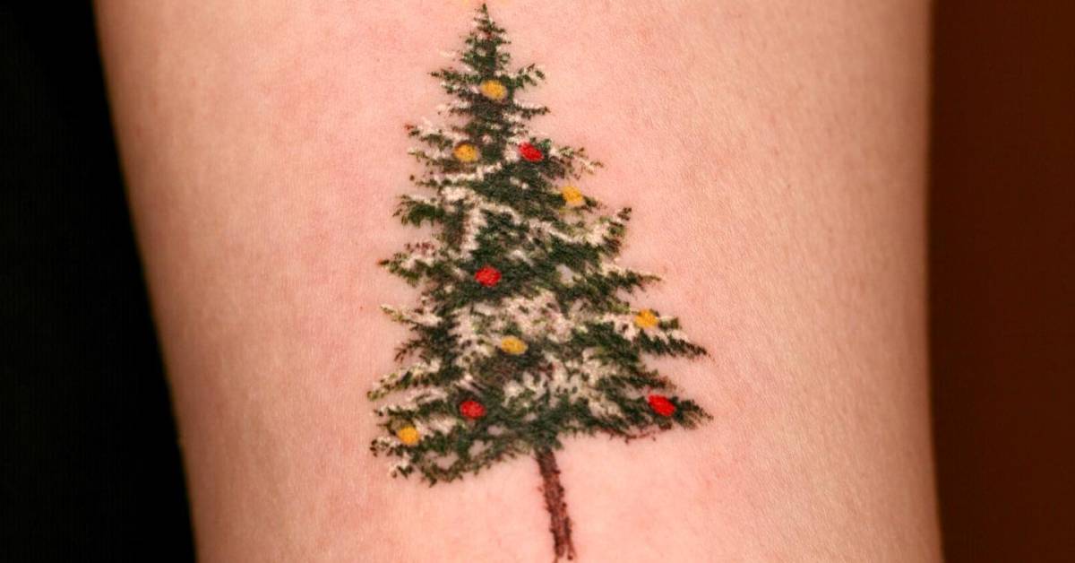 Christmas tree tattoo located on the bicep.