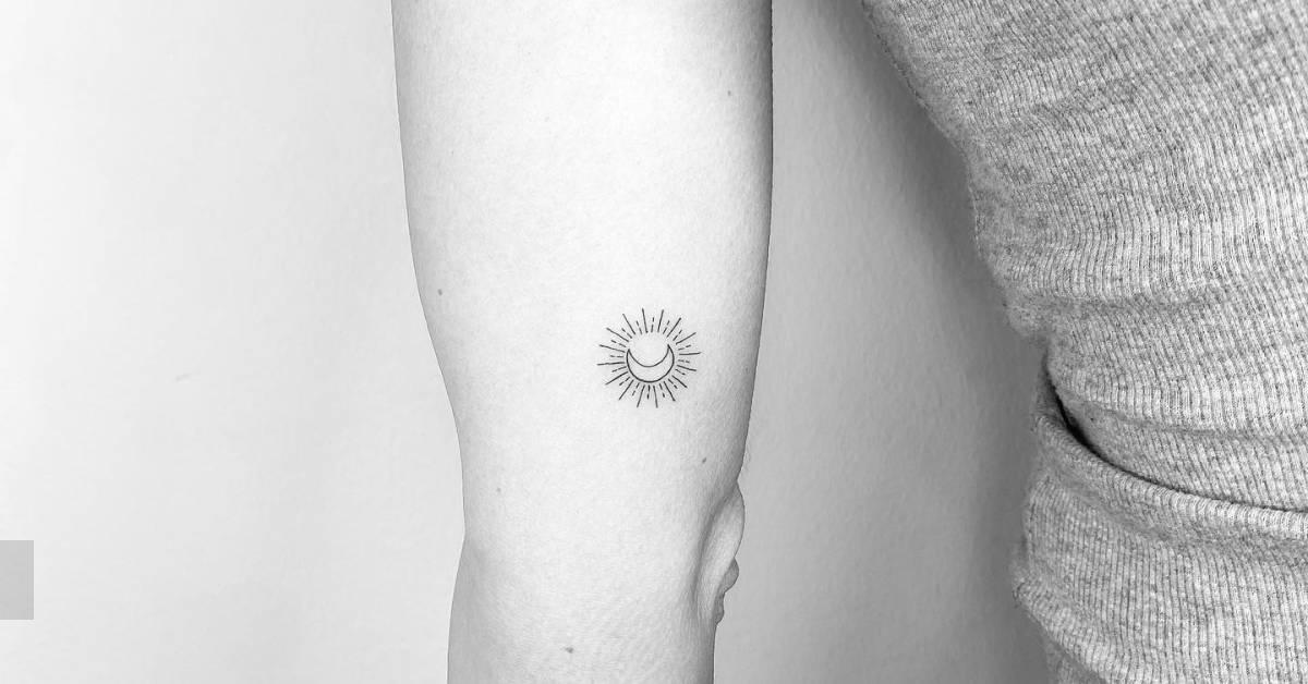 Minimalistic style eclipse tattoo located on the inner