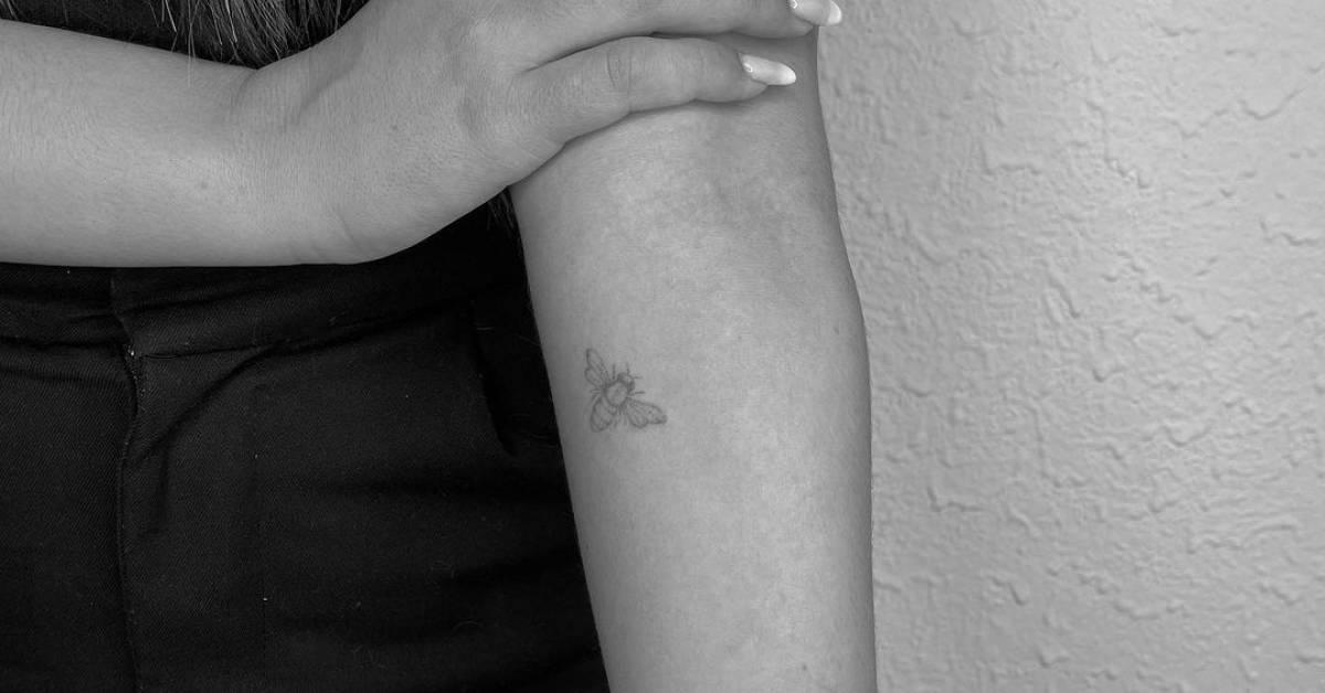 Healed bee and fresh letter "O" tattoo on the inner