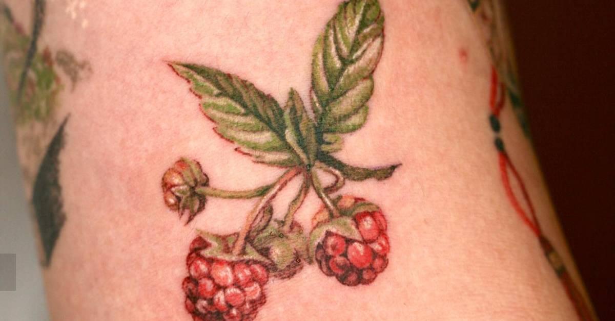 Raspberries tattoo located on the bicep, done in