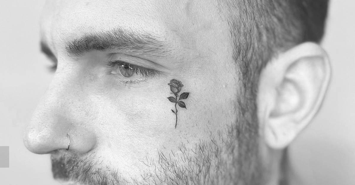 Little rose tattoo located on the face, illustrative