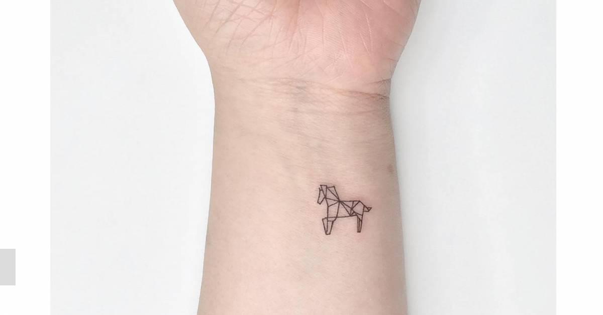 Fine line style origami horse tattoo located on the