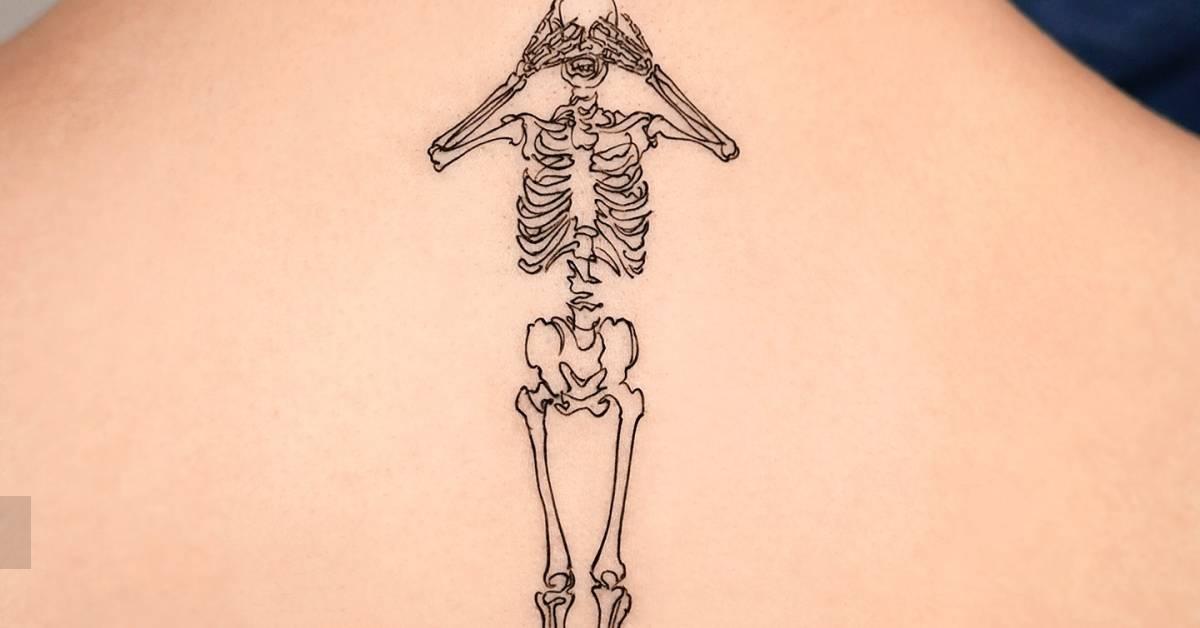 Sketch work skeleton tattoo located on the upper back.