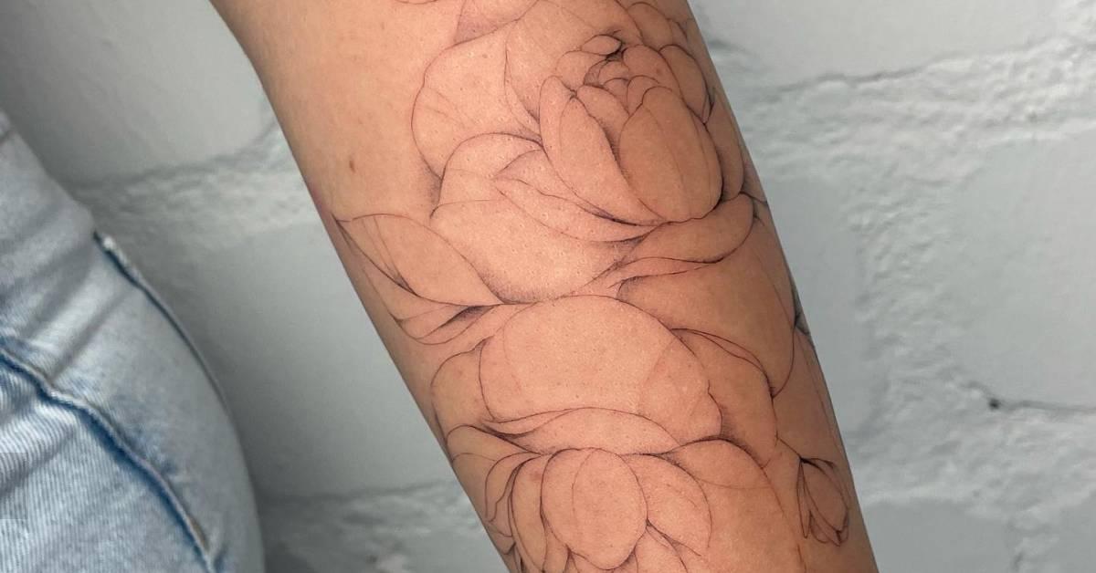 Fine line style peonies tattoo placed on the forearm.