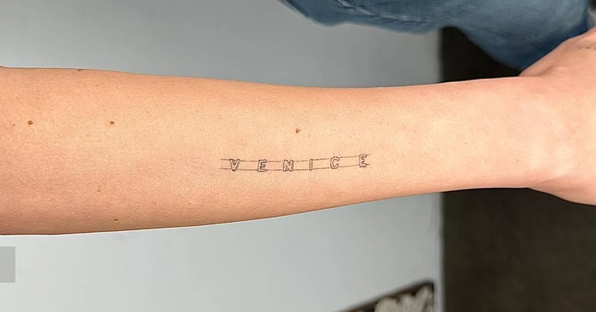 Venice sign tattoo located on the forearm.