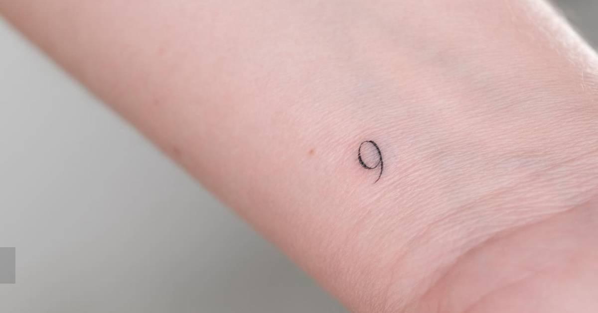 Tiny tattoo of the number "6" located on the wrist.