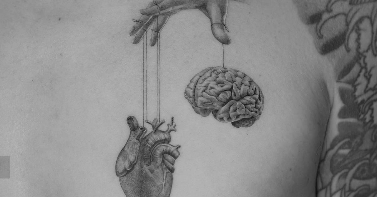 Micro-realistic style heart vs. brain tattoo located on