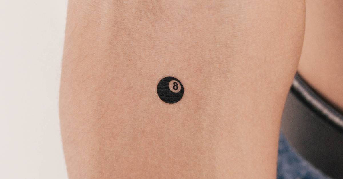 Minimalistic style eight ball temporary tattoo located