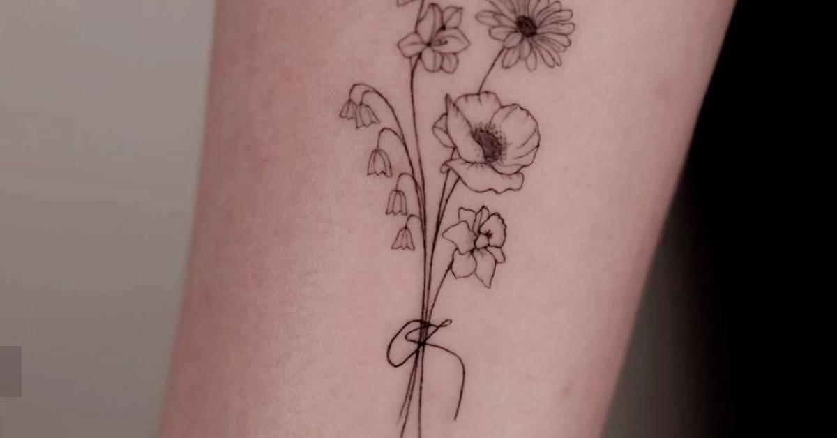 Fine line style flower bouquet tattoo located on the