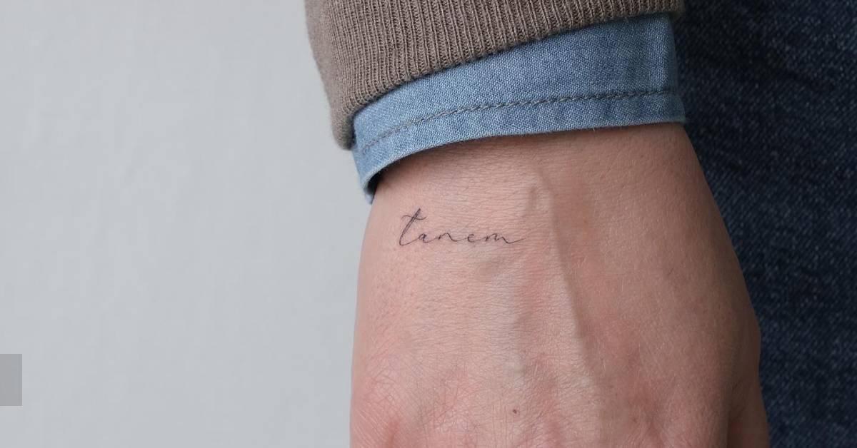 Tattoo of the word "tanem" done on the hand.