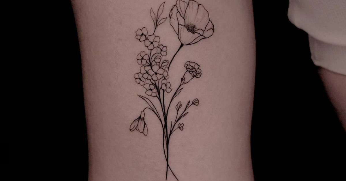 Flower bouquet tattoo located on the inner arm.