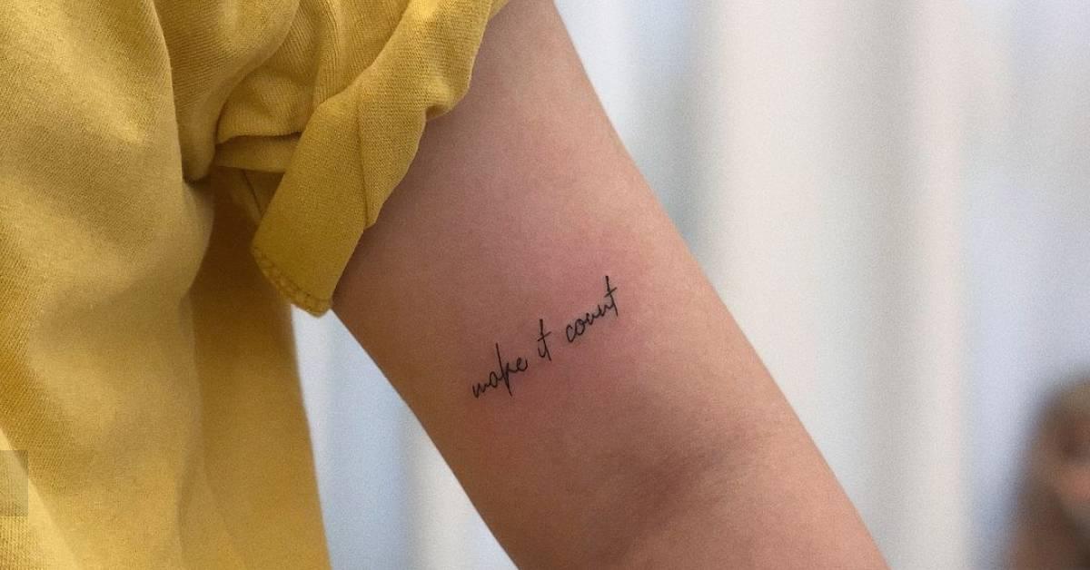 "Make it count" lettering tattoo located on the bicep.