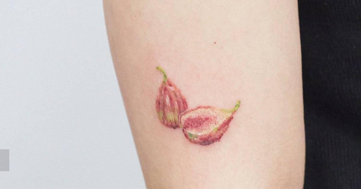 Figs tattooed on the upper arm, done in watercolor