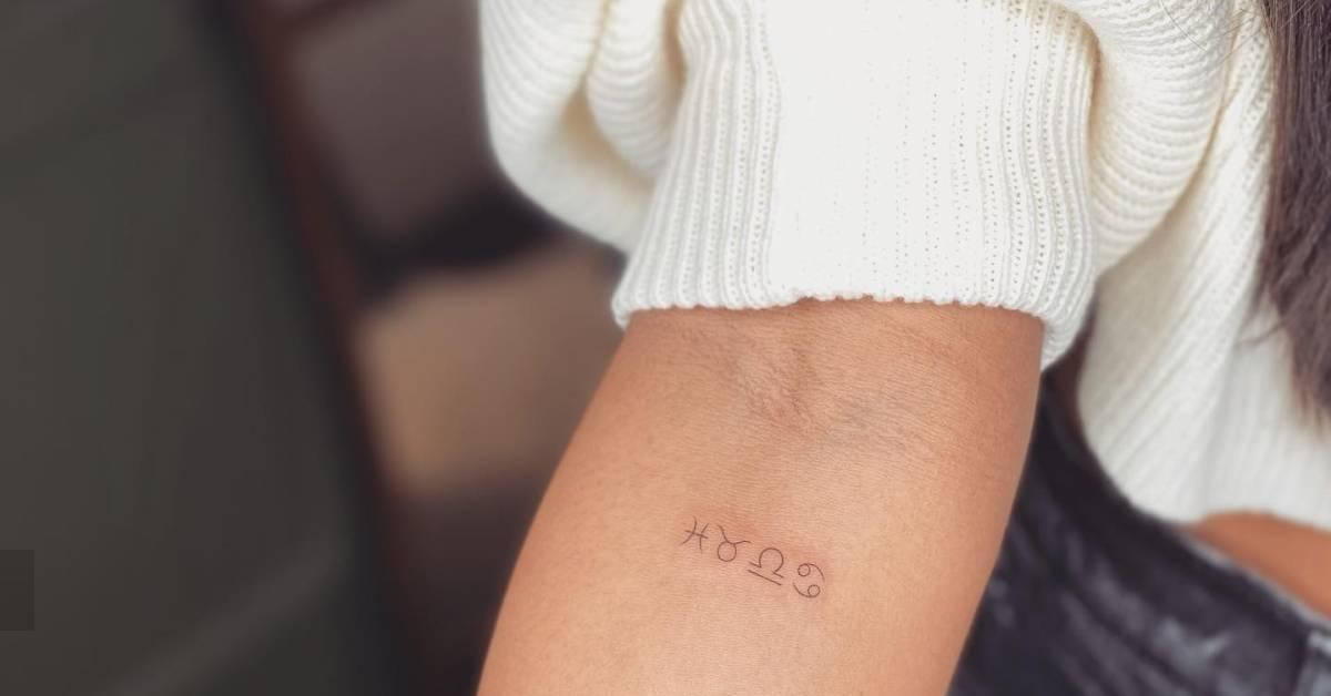 Zodiac symbols tattooed on the inner forearm,