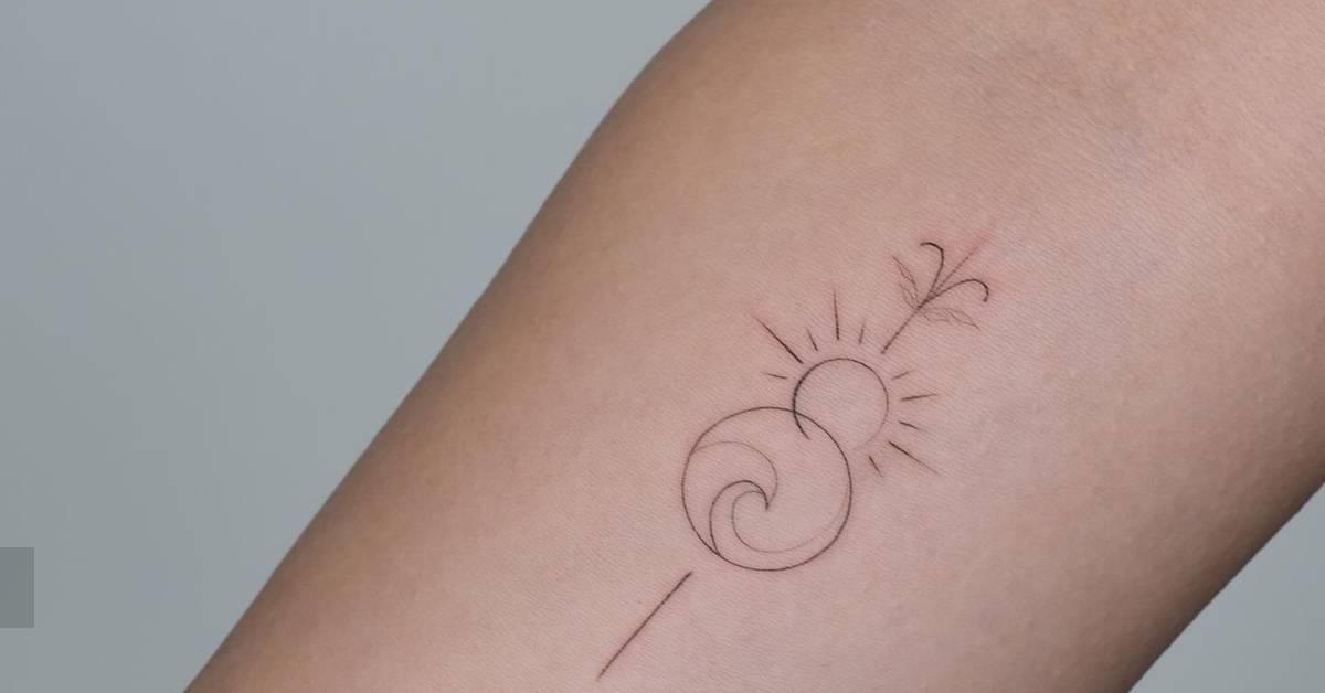 Fine line style sun and wave tattoo located on the