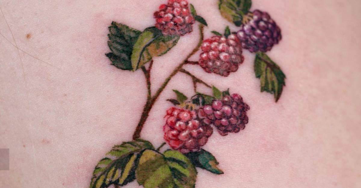 Watercolor style raspberries tattoo located on the