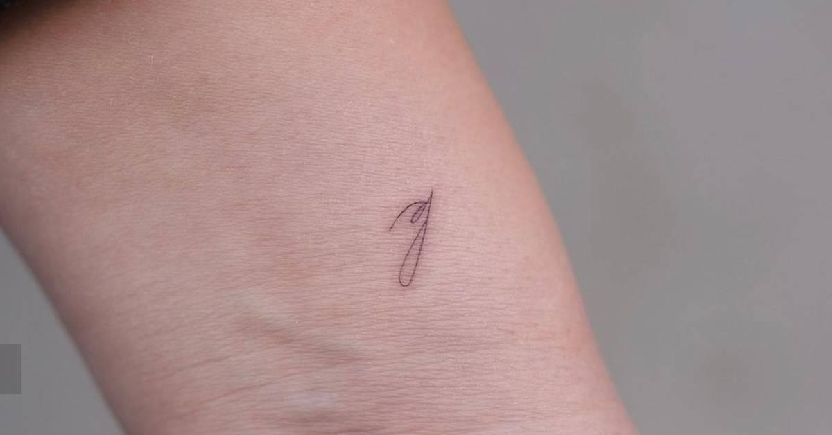 Tiny letter "K" tattoo located on the wrist.