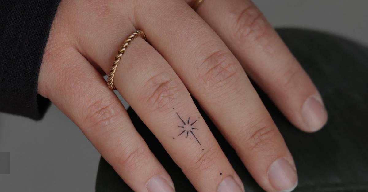 Tiny minimalistic star tattoo done on the finger.