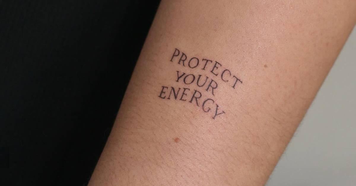 "Protect your energy" lettering tattoo done on the