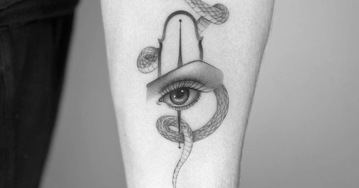 Single needle snake and eye tattoo located on the inner
