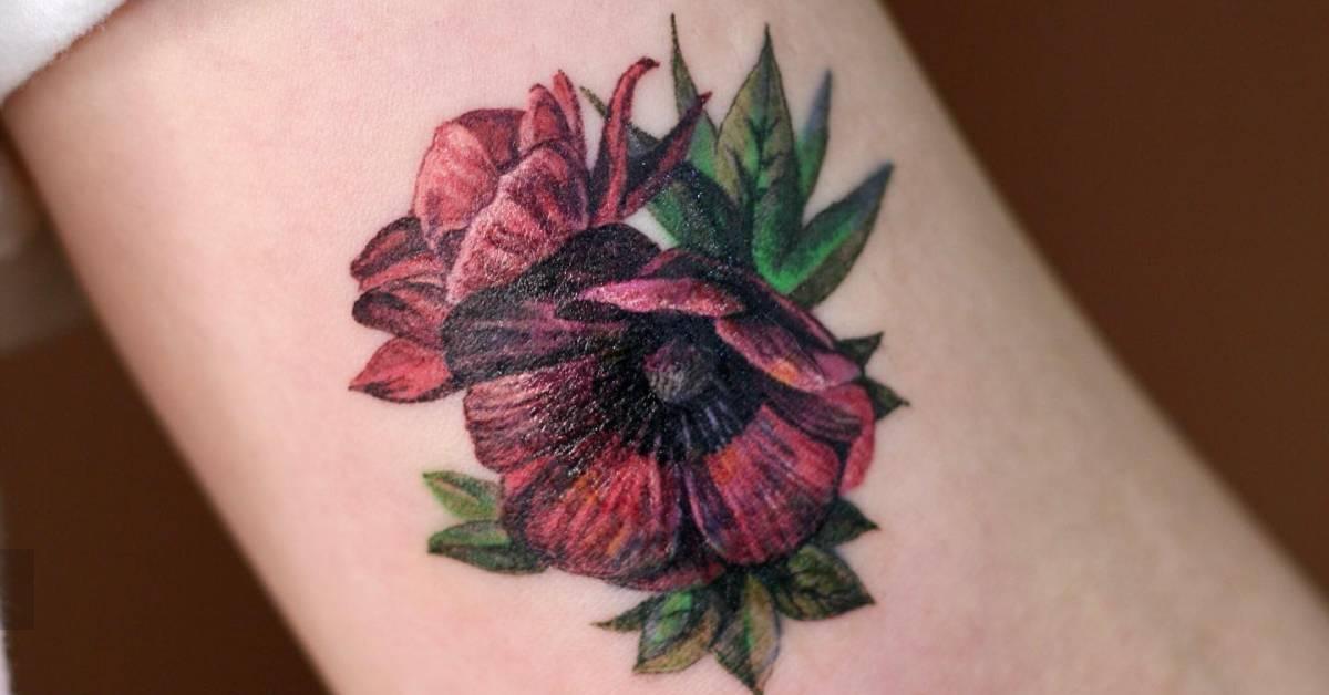 Anemone flower tattooed on the inner arm, watercolor