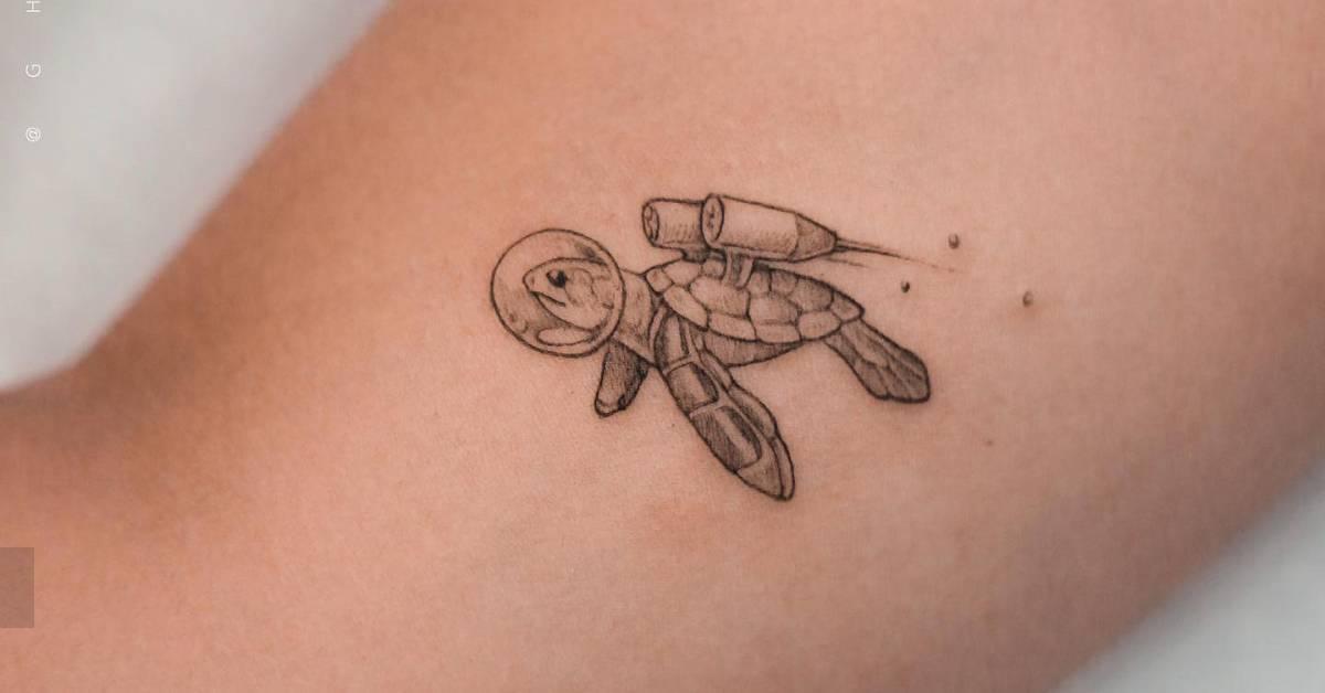 Astro turtle tattoo located on the inner forearm,