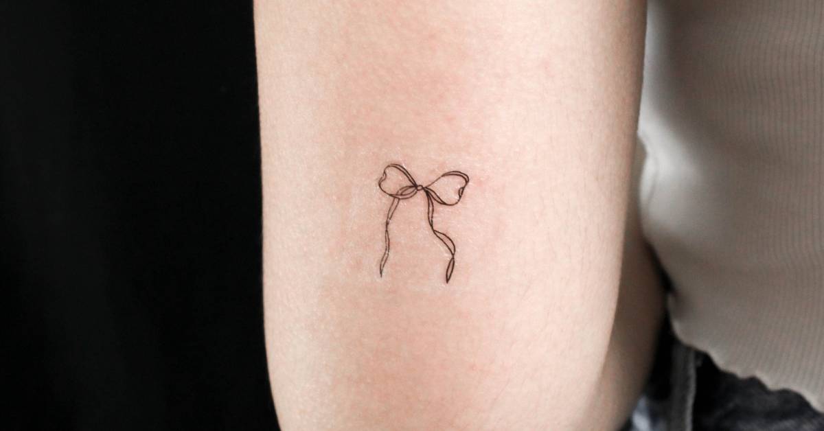 Fine line style ribbon bow temporary tattoo done on the