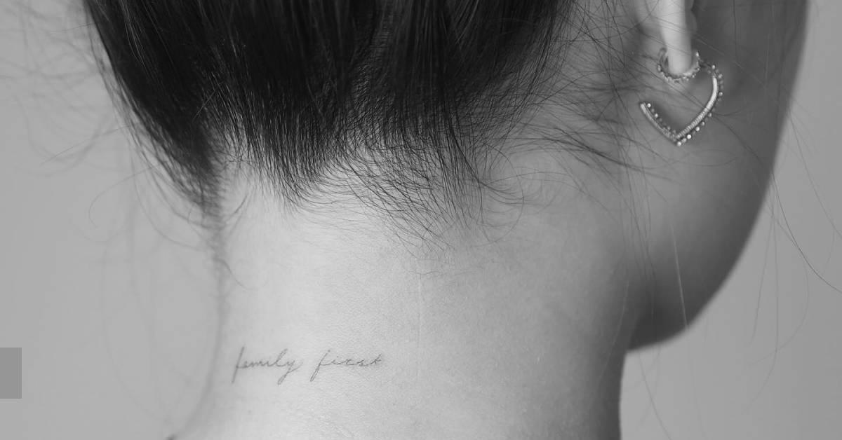 "Family first" lettering tattoo placed on the back of
