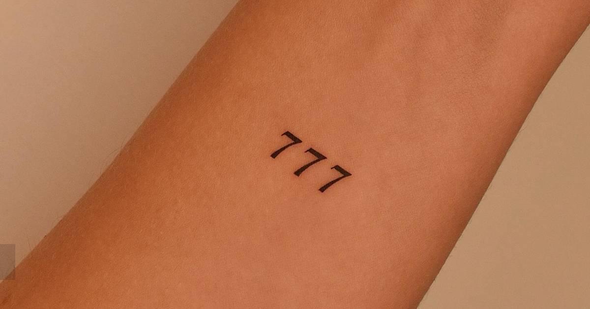 Angel number "777" tattooed on the wrist.