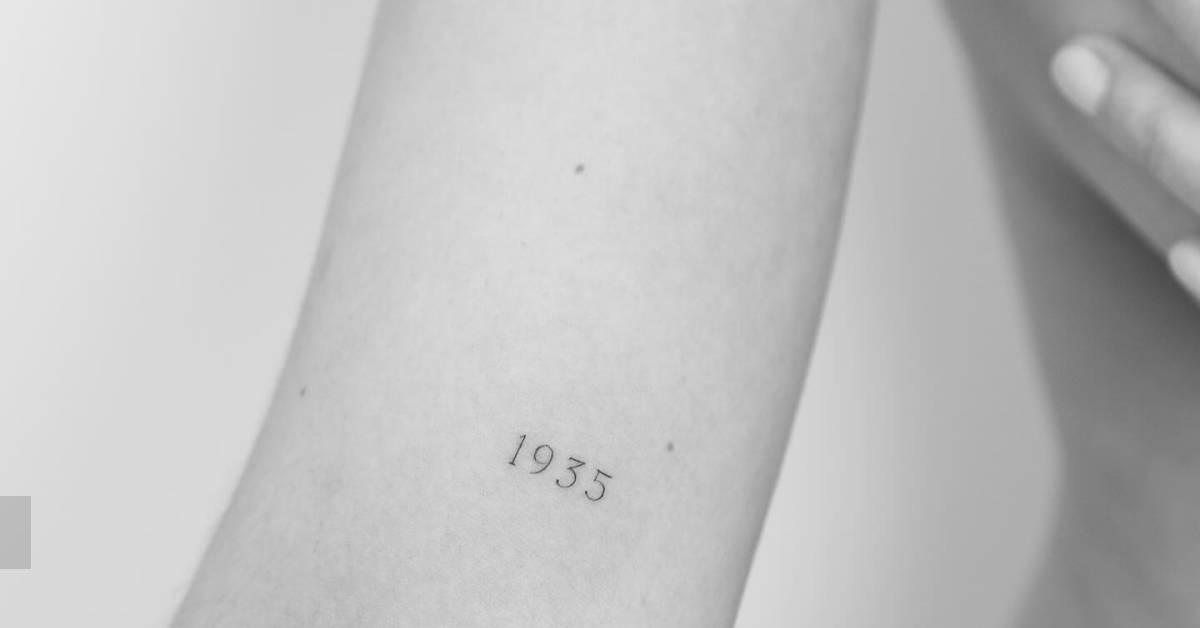 "1935" lettering tattoo located on the inner arm.