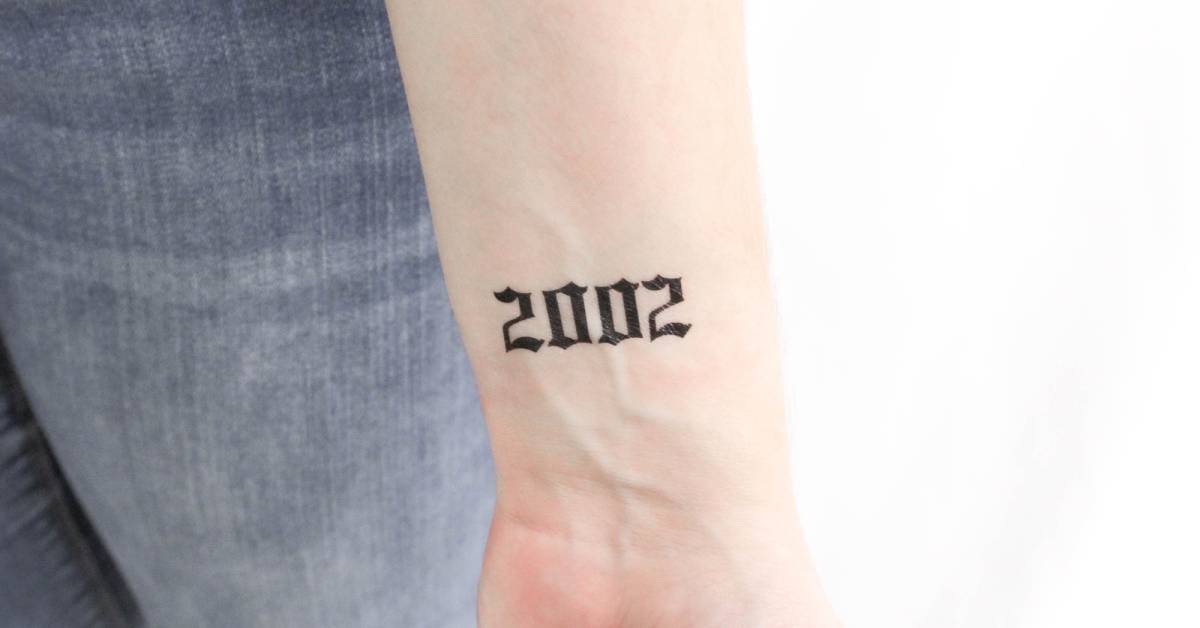 Gothic "2002" birth year temporary tattoo placed on the
