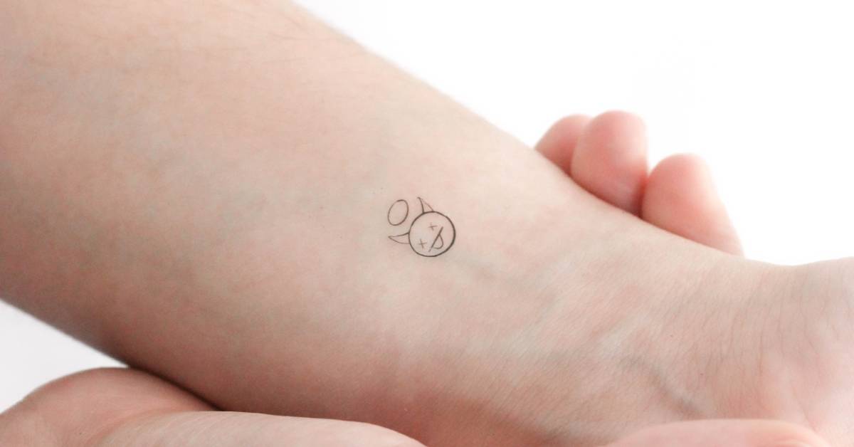Minimalistic devil temporary tattoo located on the