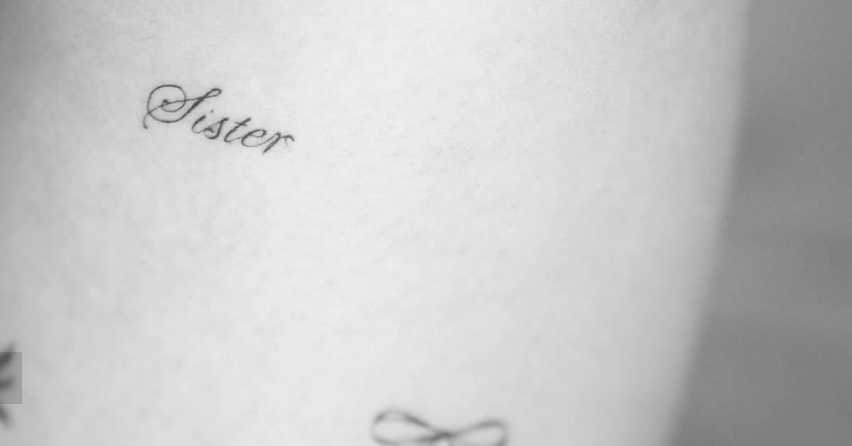 Tattoo of the word "sister" located on the calf.