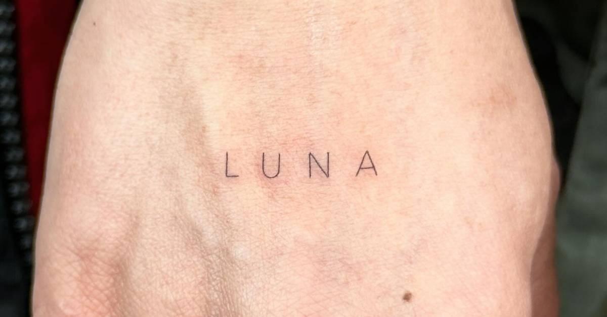 Tattoo of the word "luna" located on the hand.