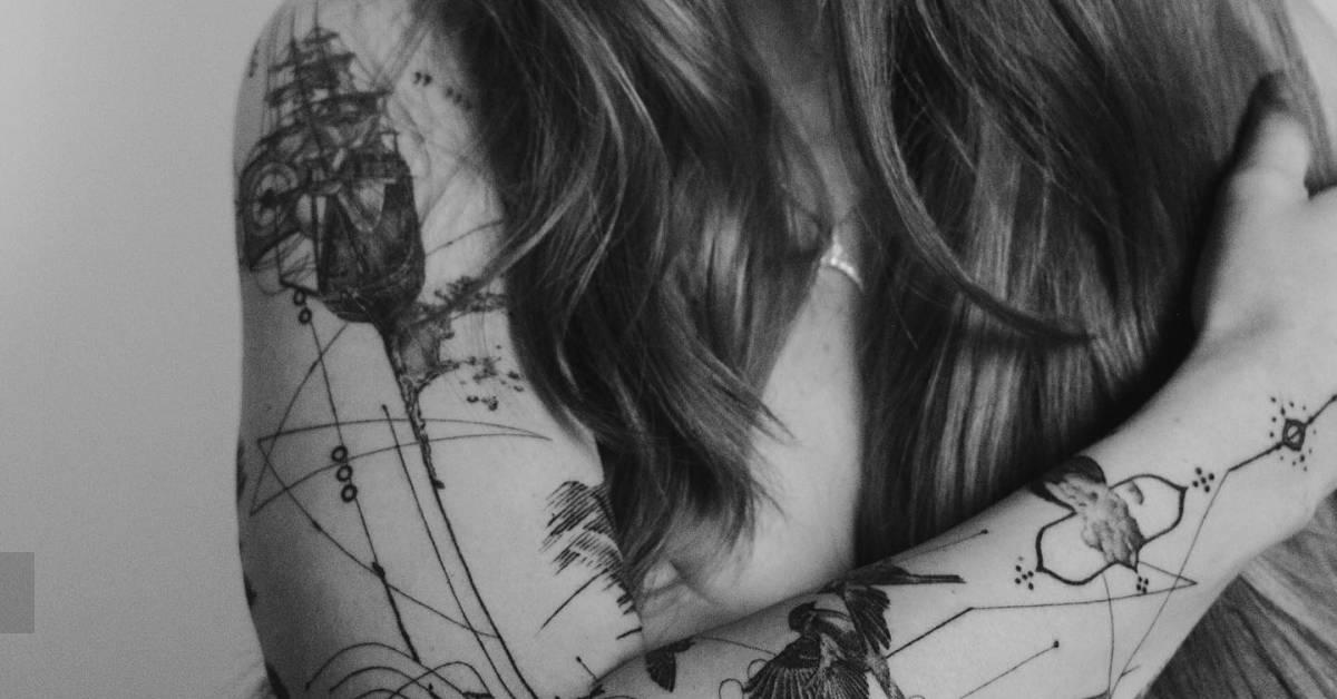 Graphic style arm composition tattoos.