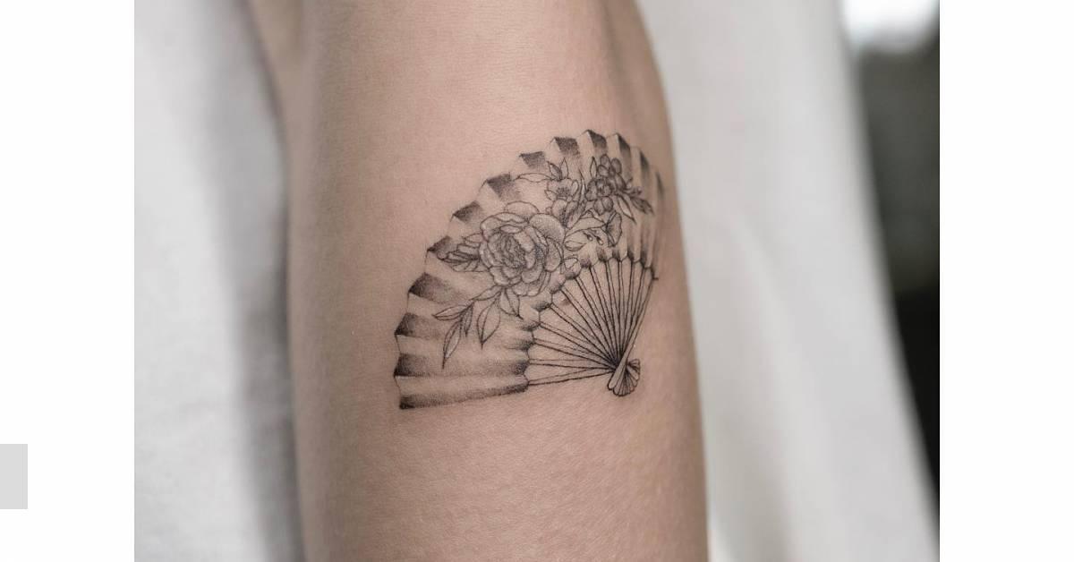 Micro-realistic hand fan tattoo done on the forearm.