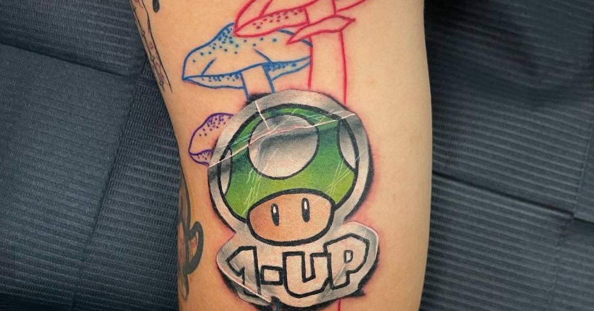 Super Mushroom sticker tattoo located on the tricep.