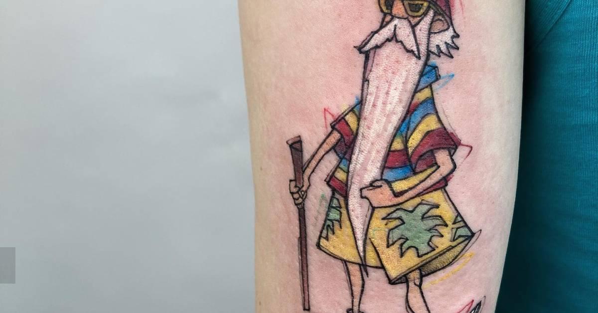 Sketch work style Merlin tattoo located on the tricep.