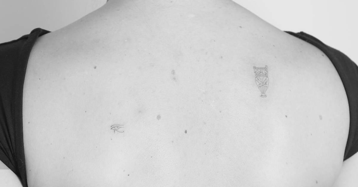 Fine line style back composition tattoos.