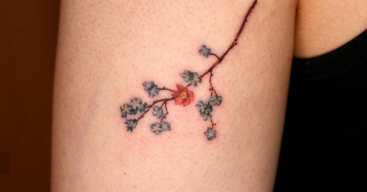 Flower branch tattoo located on the tricep, watercolor