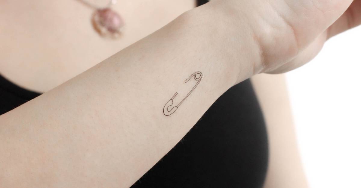Fine line safety pin temporary tattoo located on the