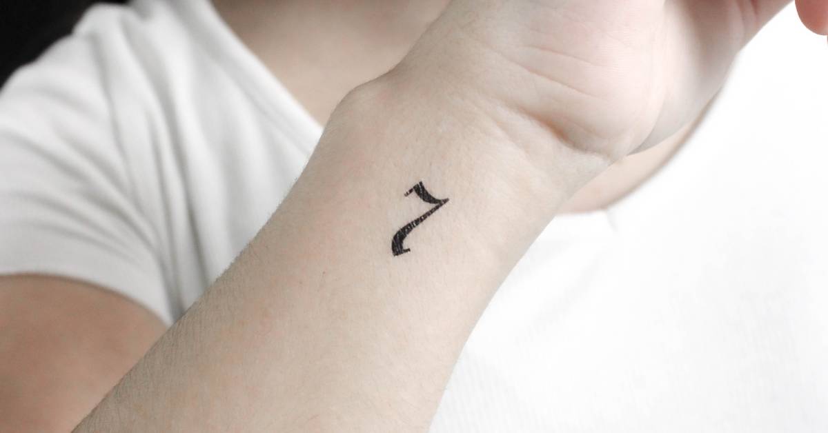Gothic number "7" temporary tattoo located on the