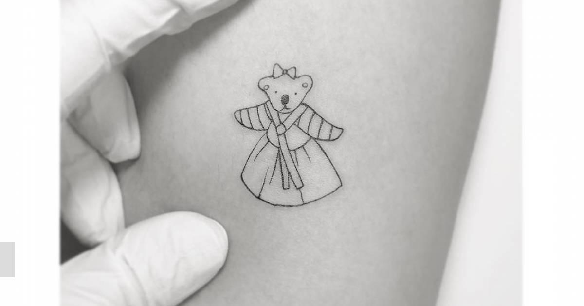 Korean teddy bear tattoo located on the inner arm.