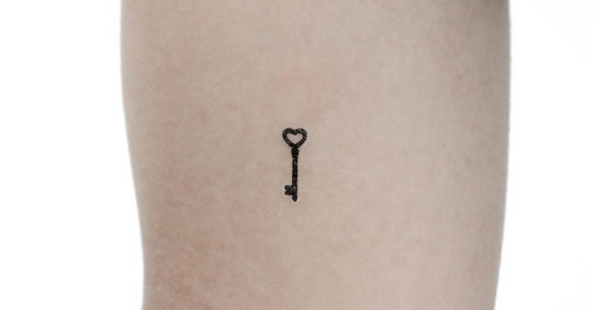 Minimalistic style love key temporary tattoo located on