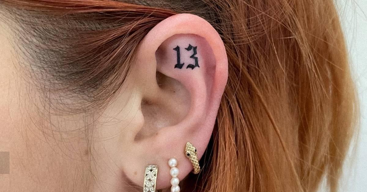 Tattoo of the number "13" located on the ear.